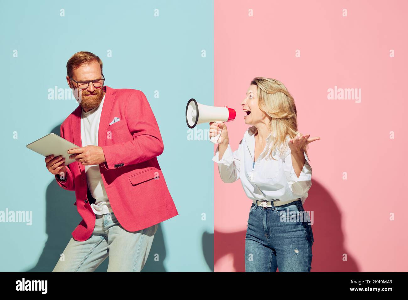 Shout. Emotional young redheaded man and blonde woman isolated over ...