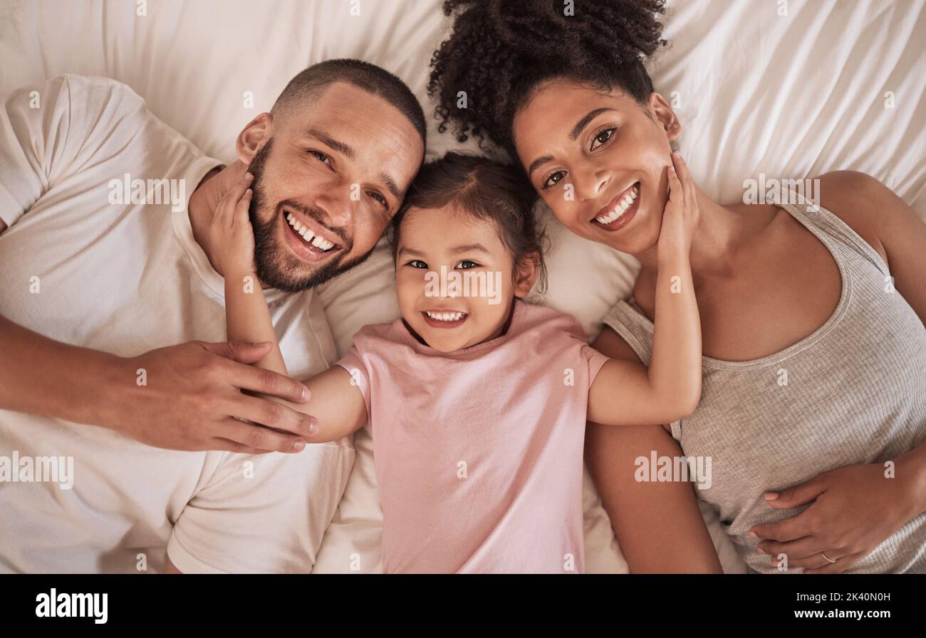Family happy, child and above bed with parents in the morning, funny ...