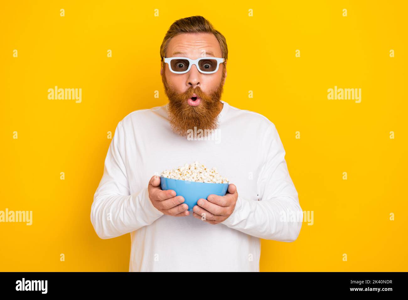 Photo of cool beard red hair man hold popcorn watch film wear eyewear ...