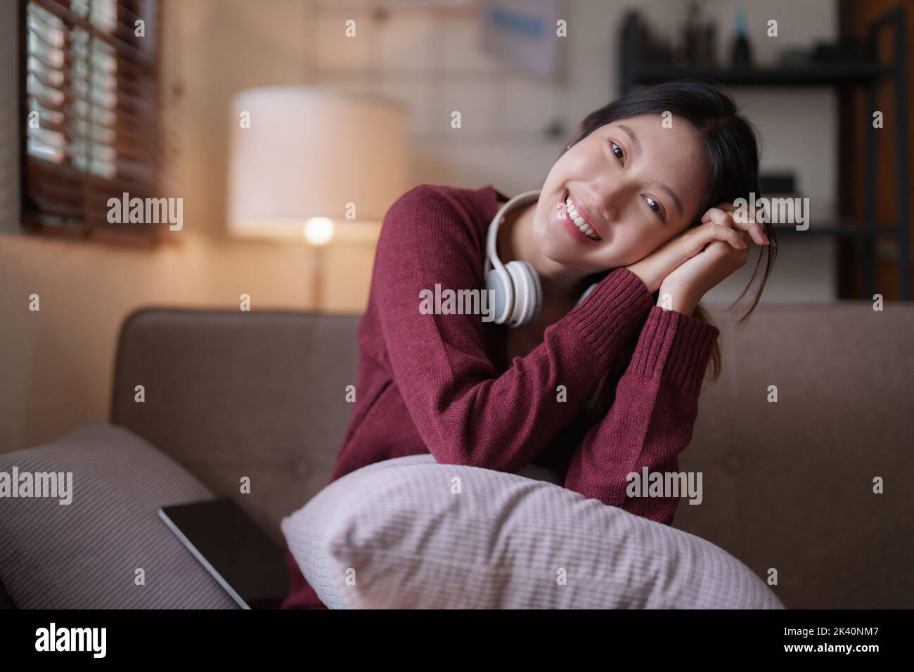 Young asian woman happy life sitting on couch cozy living room at home ...