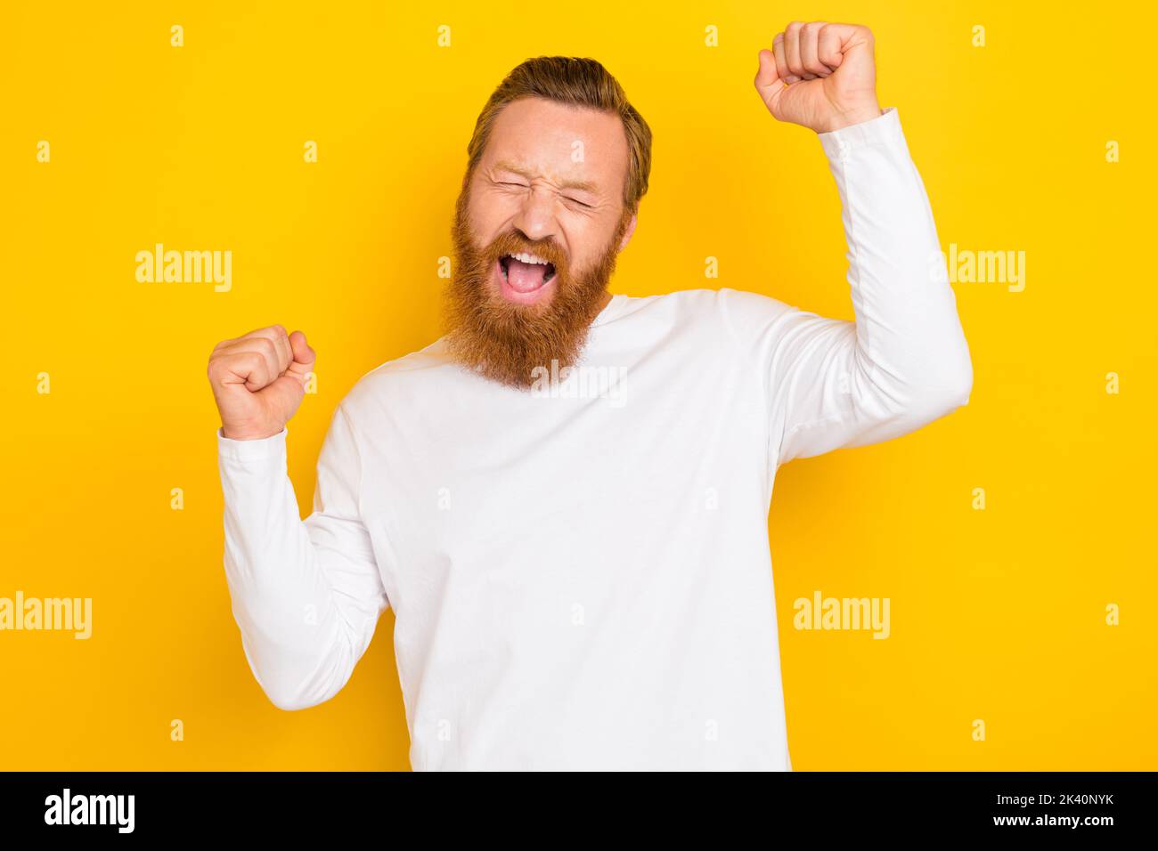 Photo of satisfied glad man raise fists closed eyes open mouth scream ...