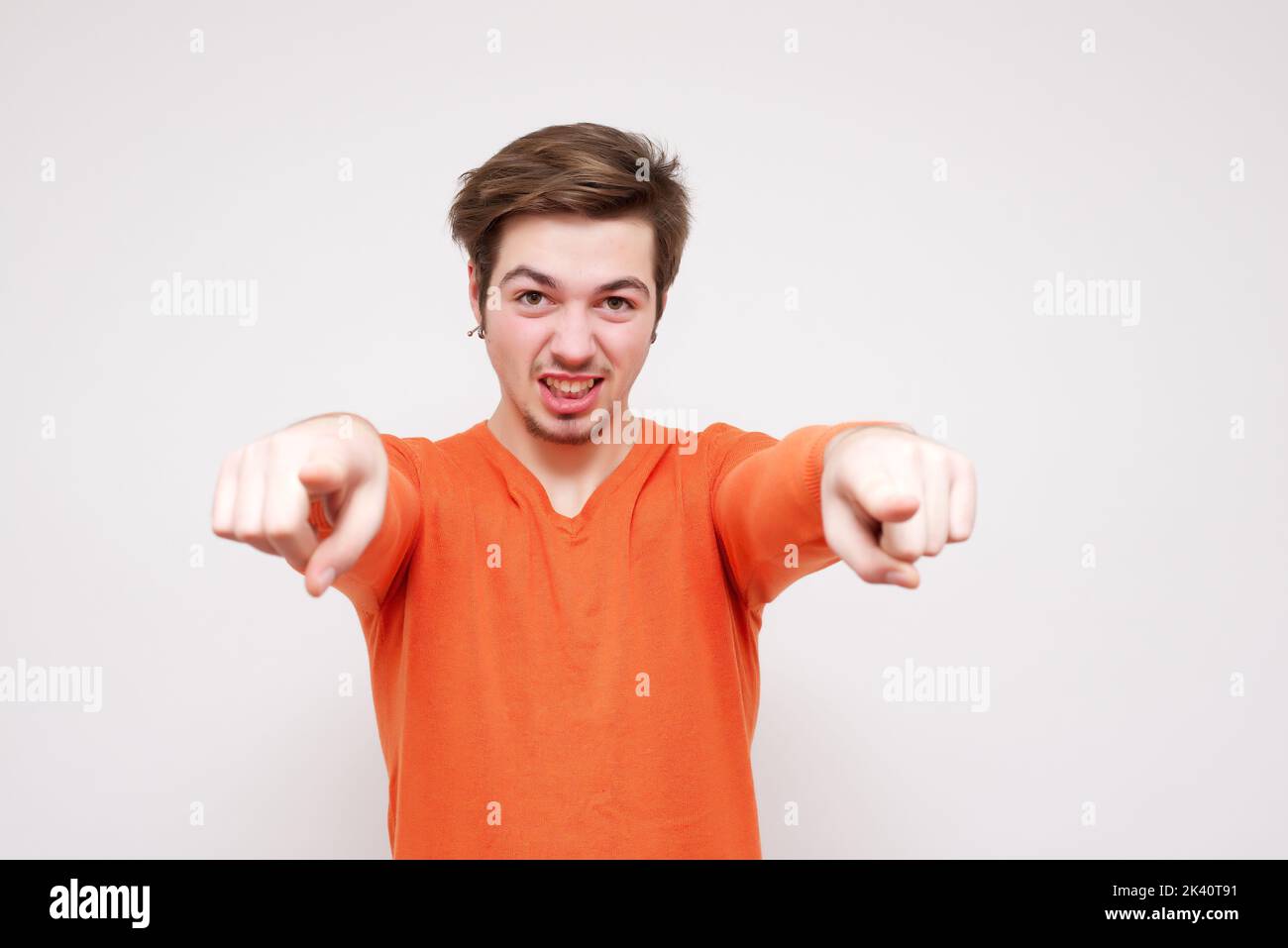 Attractive model pointing to camera on white background stock photo ...