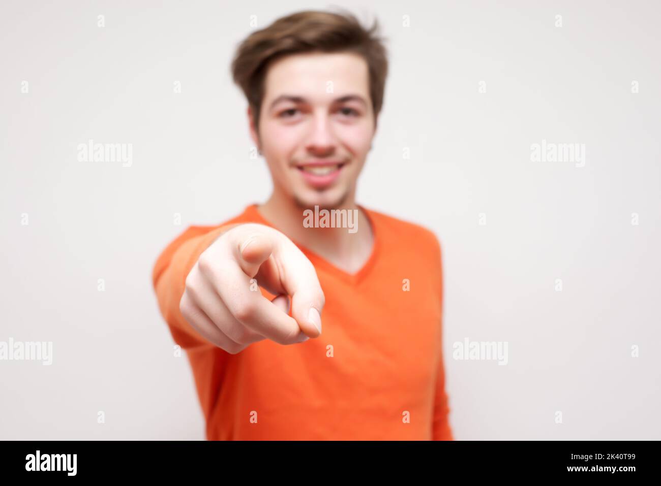 Attractive model pointing to camera on white background stock photo ...