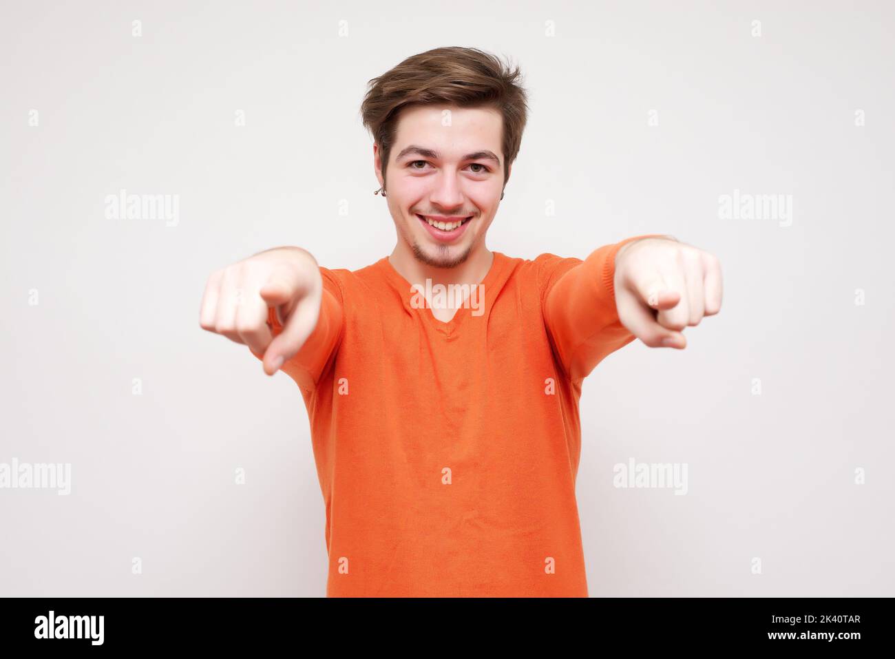 Attractive model pointing to camera on white background stock photo ...