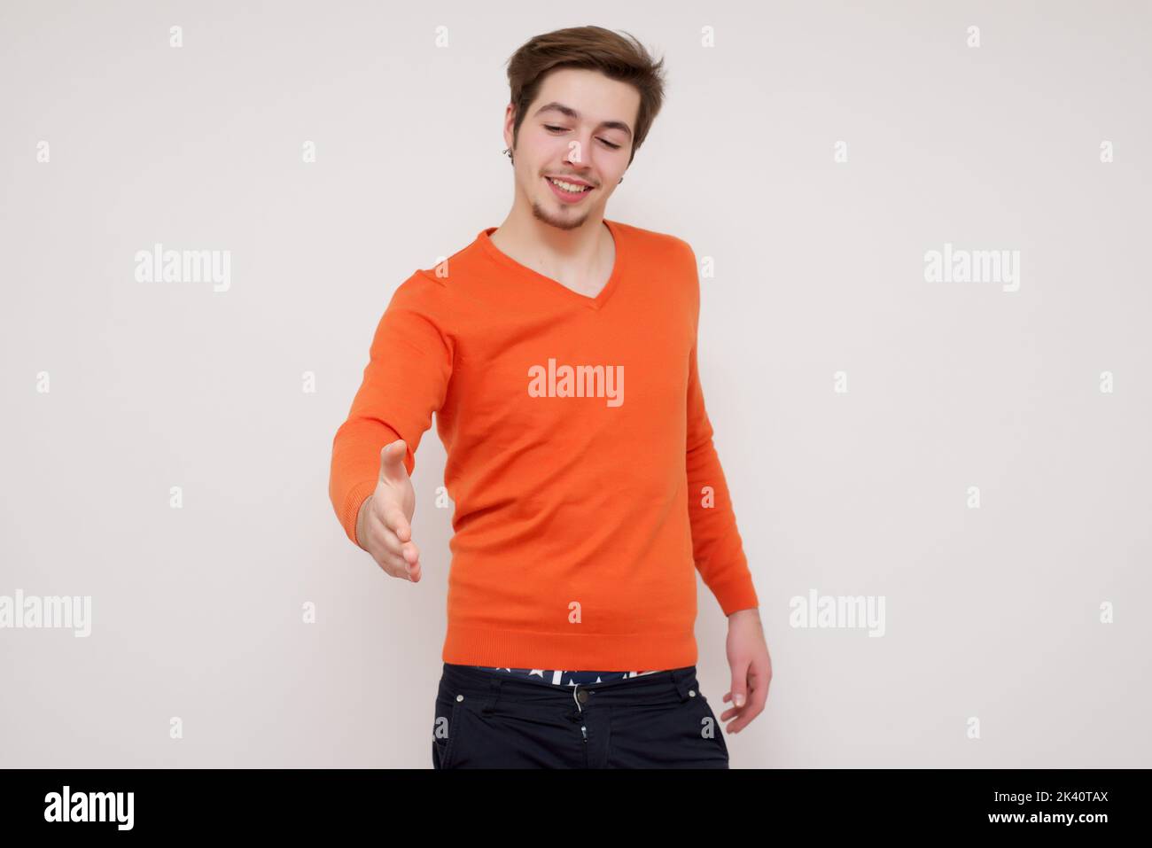 Nice to meet you! Handsome young man stretching out hand for shaking ...