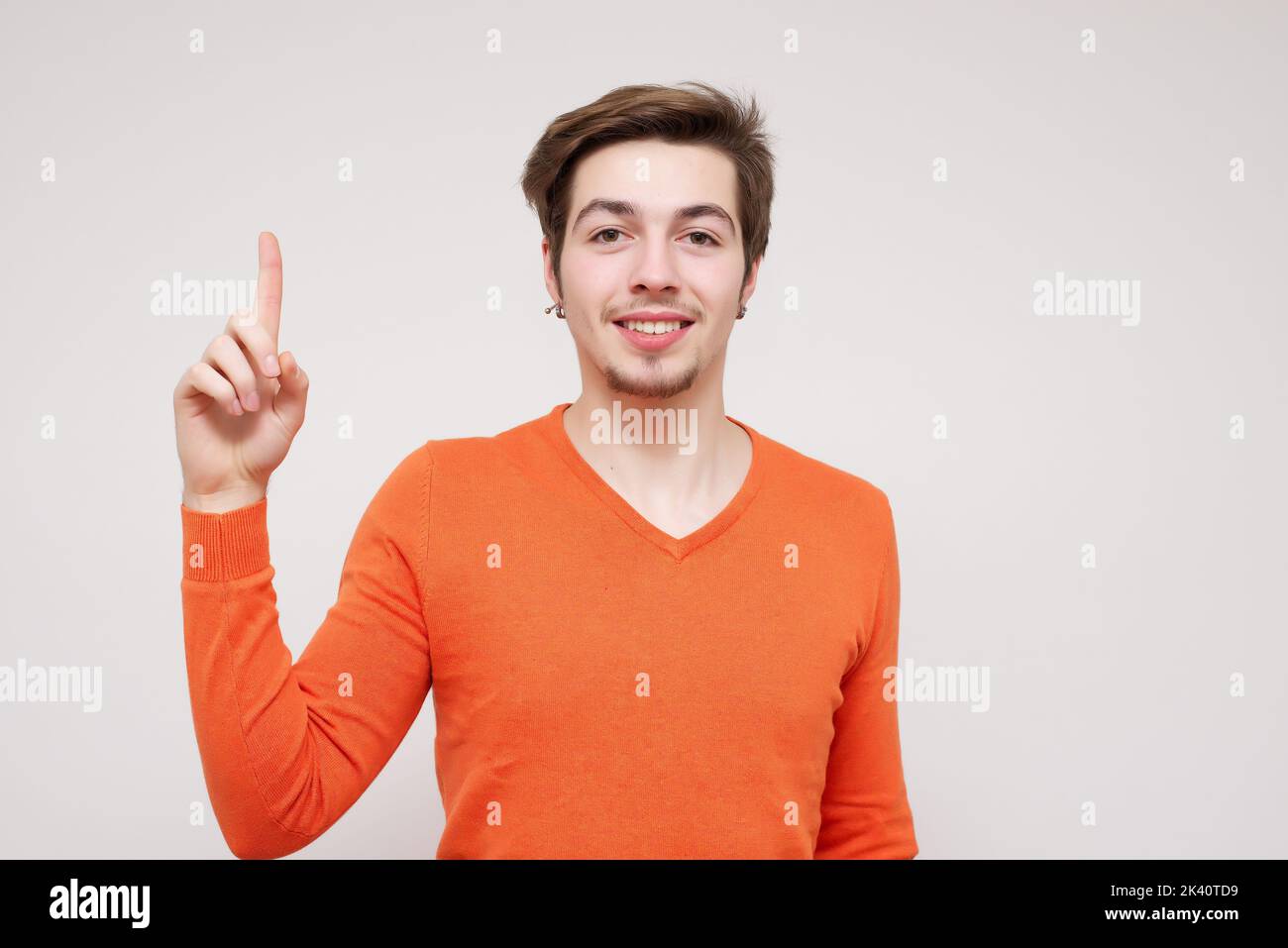 Handsome young man showing finger (isolated on white background) stock ...