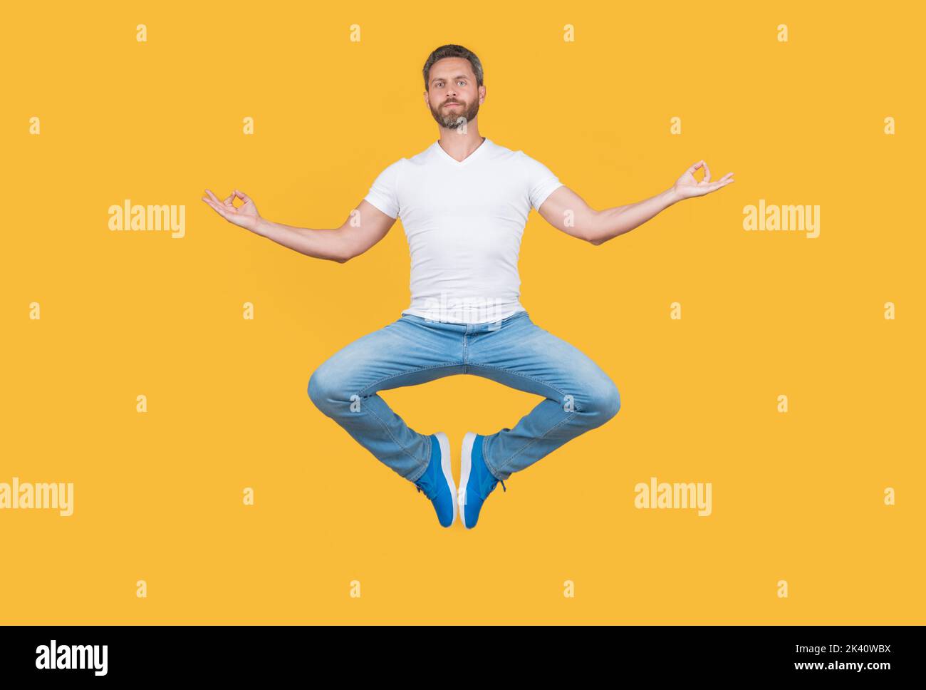 man having levitating meditation isolated on yellow background ...