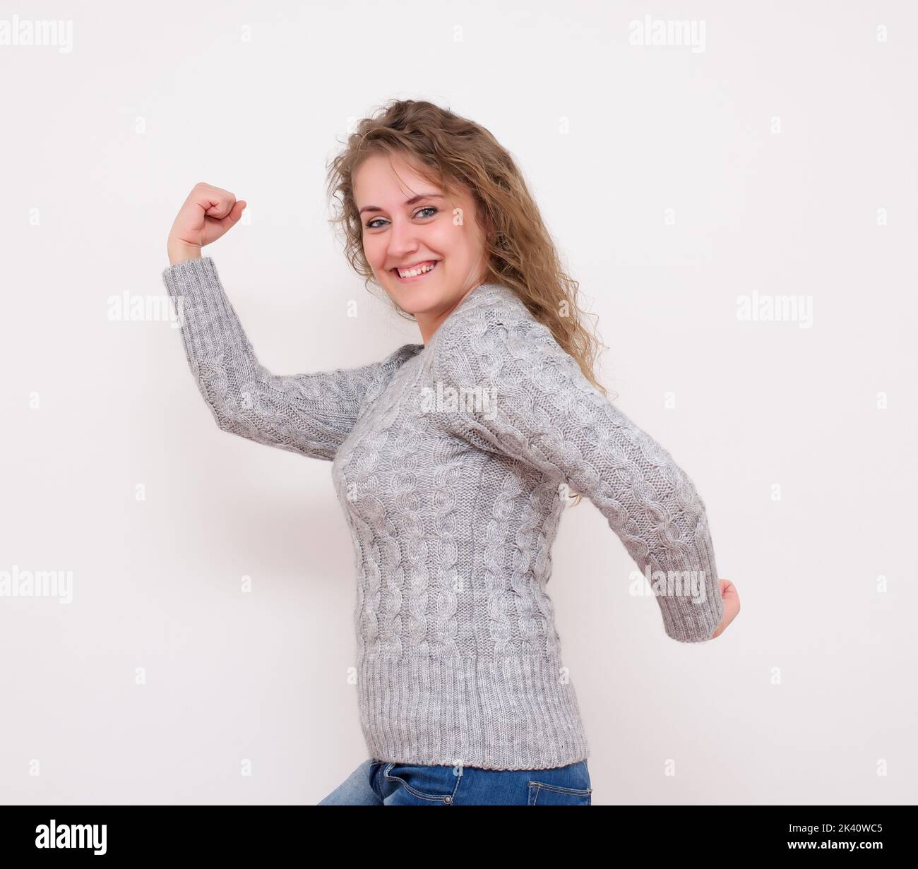 Closeup portrait of beautiful, pretty young model woman flexing muscles ...