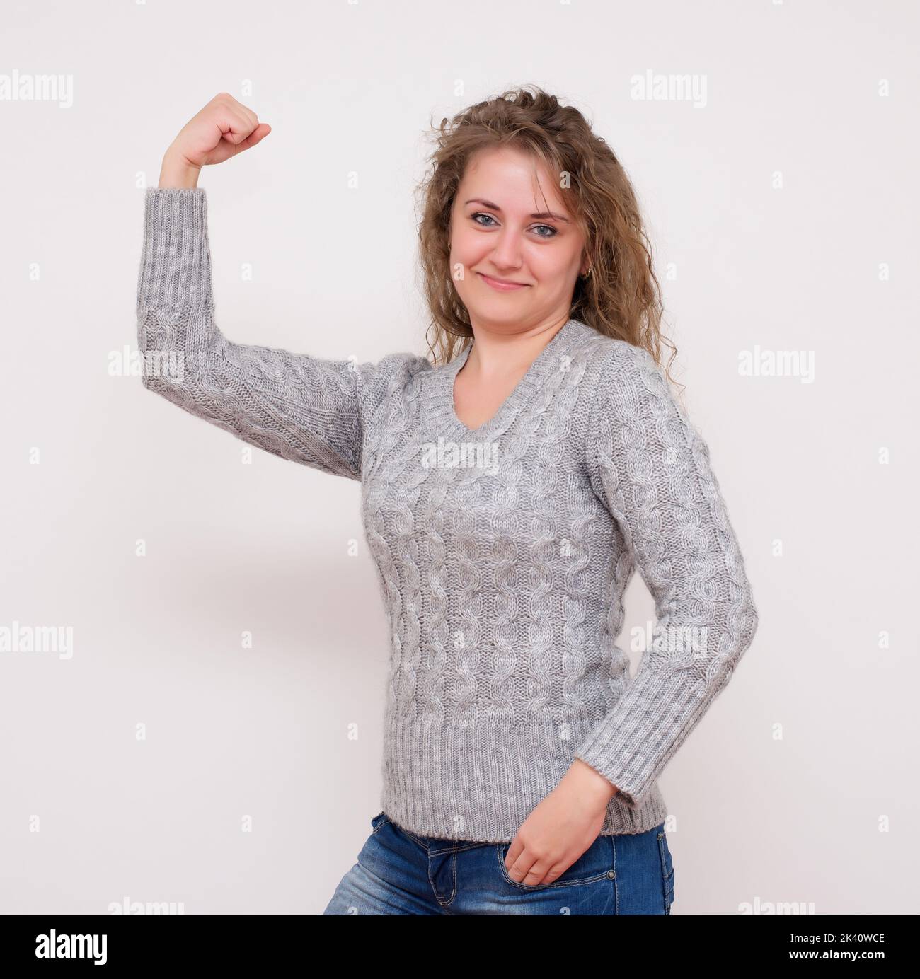 Closeup portrait of beautiful, pretty young model woman flexing muscles ...