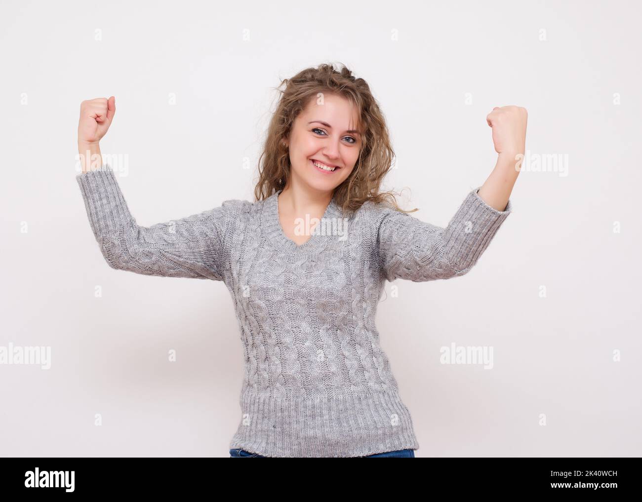 Closeup portrait of beautiful, pretty young model woman flexing muscles ...
