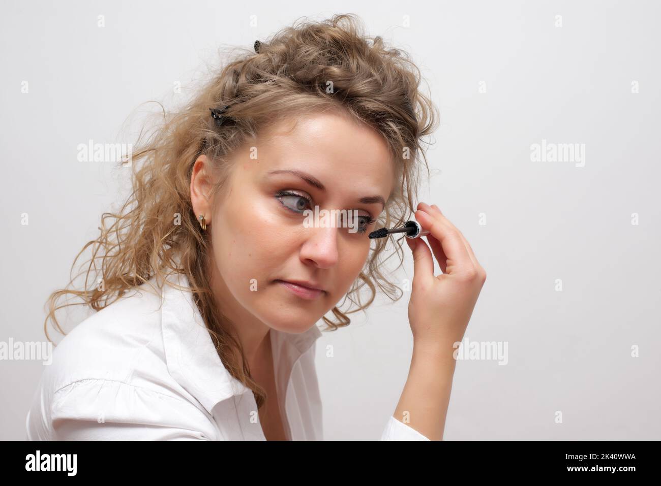 Makeup woman. Cute cosmetics woman having fun with make-up products ...