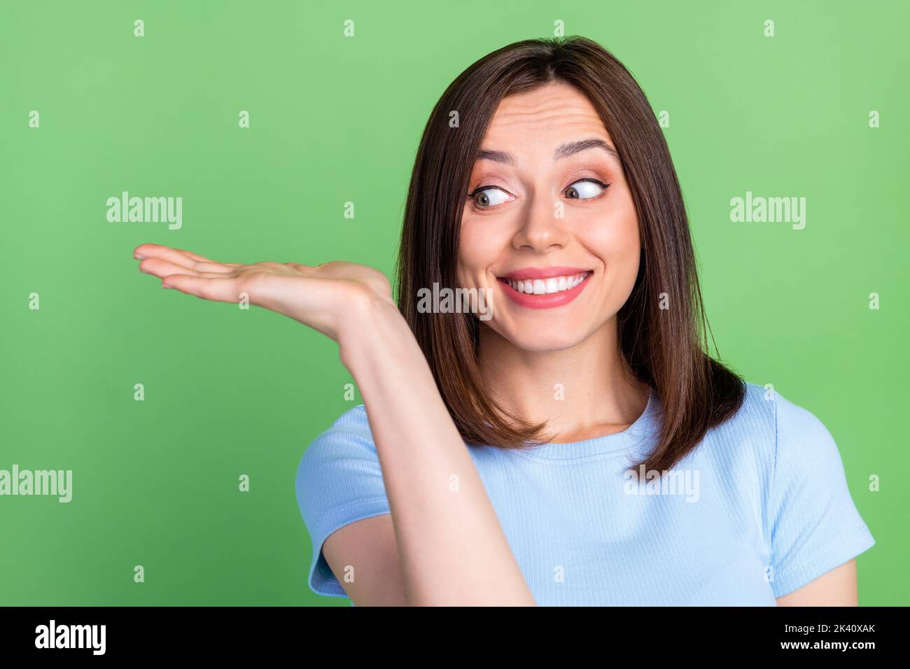 Photo of cheerful pretty girl look arm palm hold demonstrate empty ...