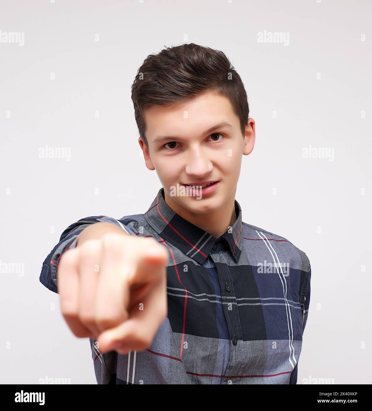 Attractive model pointing to camera on white background stock photo ...