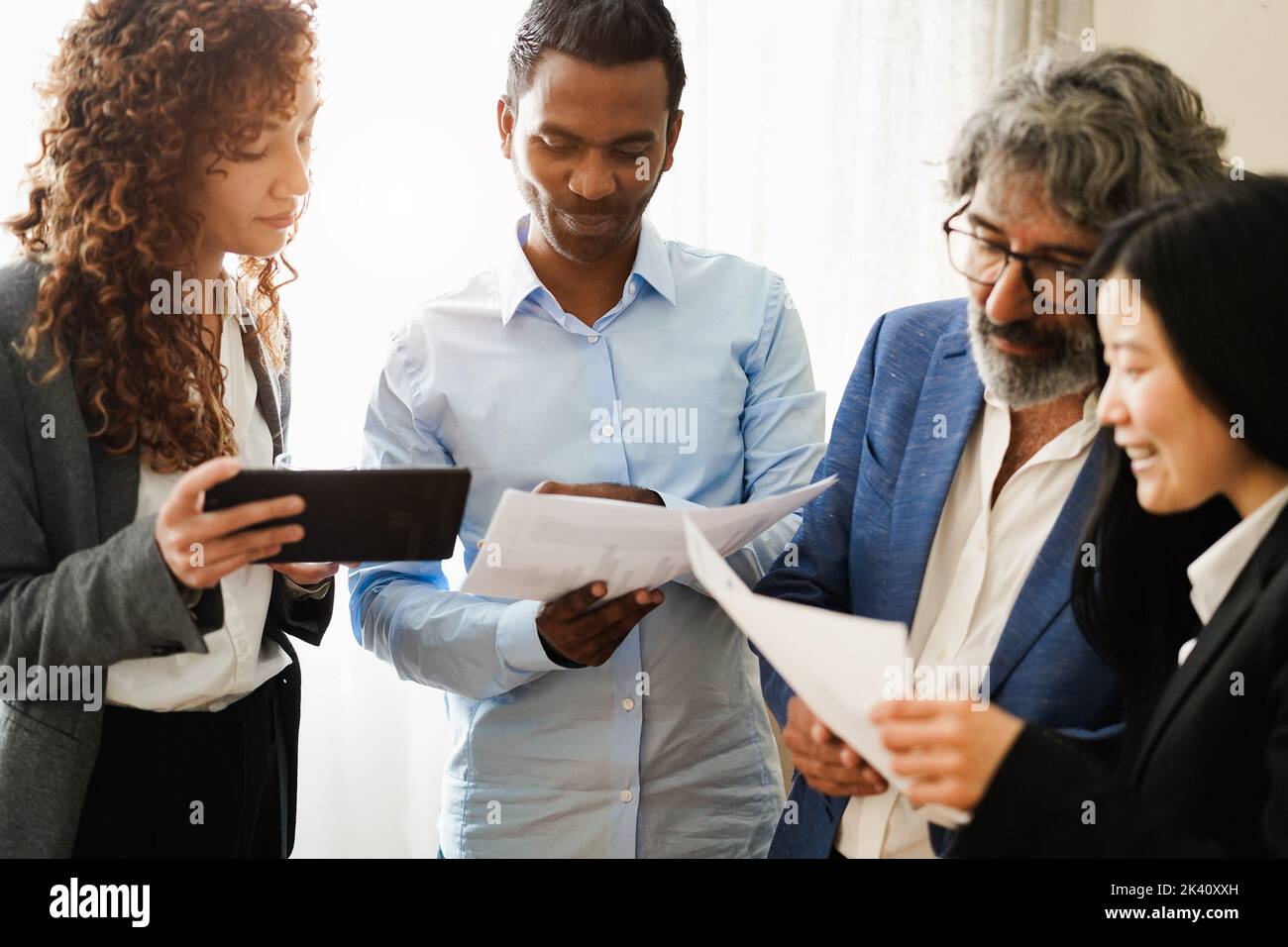 Multiracial business people working inside bank office - Soft focus on ...