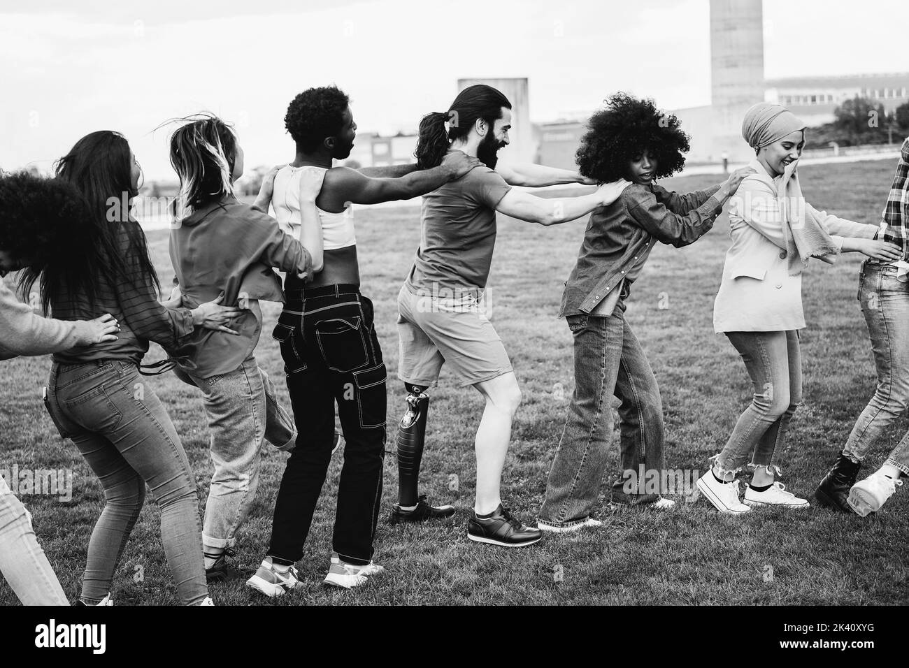 Young diverse people having fun outdoor dancing together - Focus on leg ...