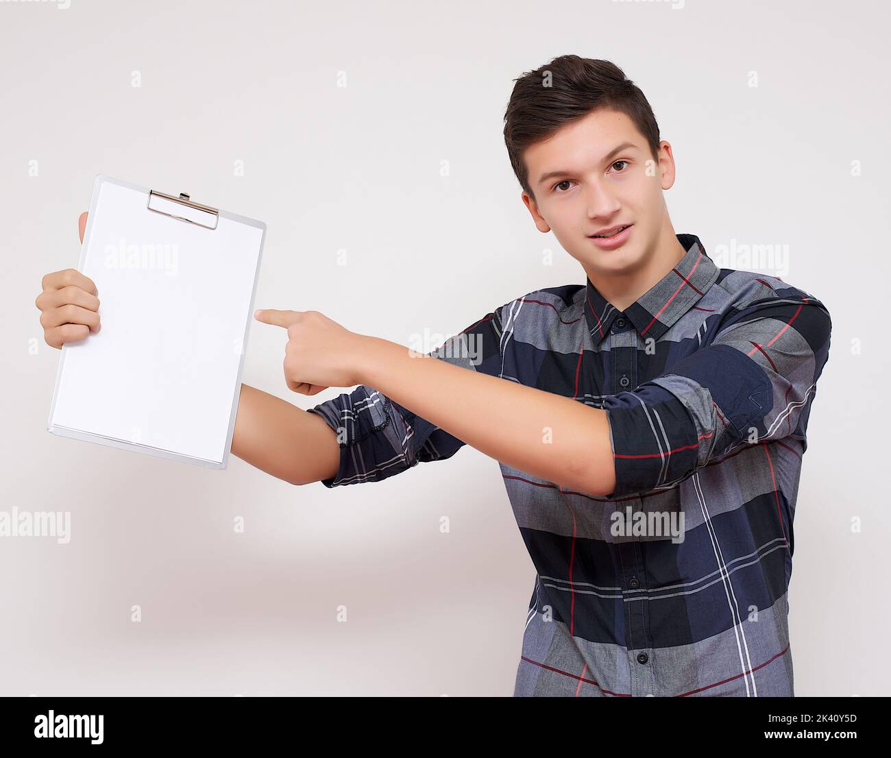 Happy smiling young business man showing blank signboard, isolated over ...