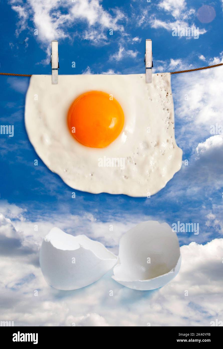fried egg hanging on a rope with pin clothes Stock Photo - Alamy