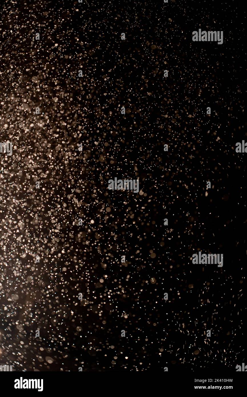 Gold dust particles abstract Bokeh star particle on Black Background. Futuristic glittering dots ...