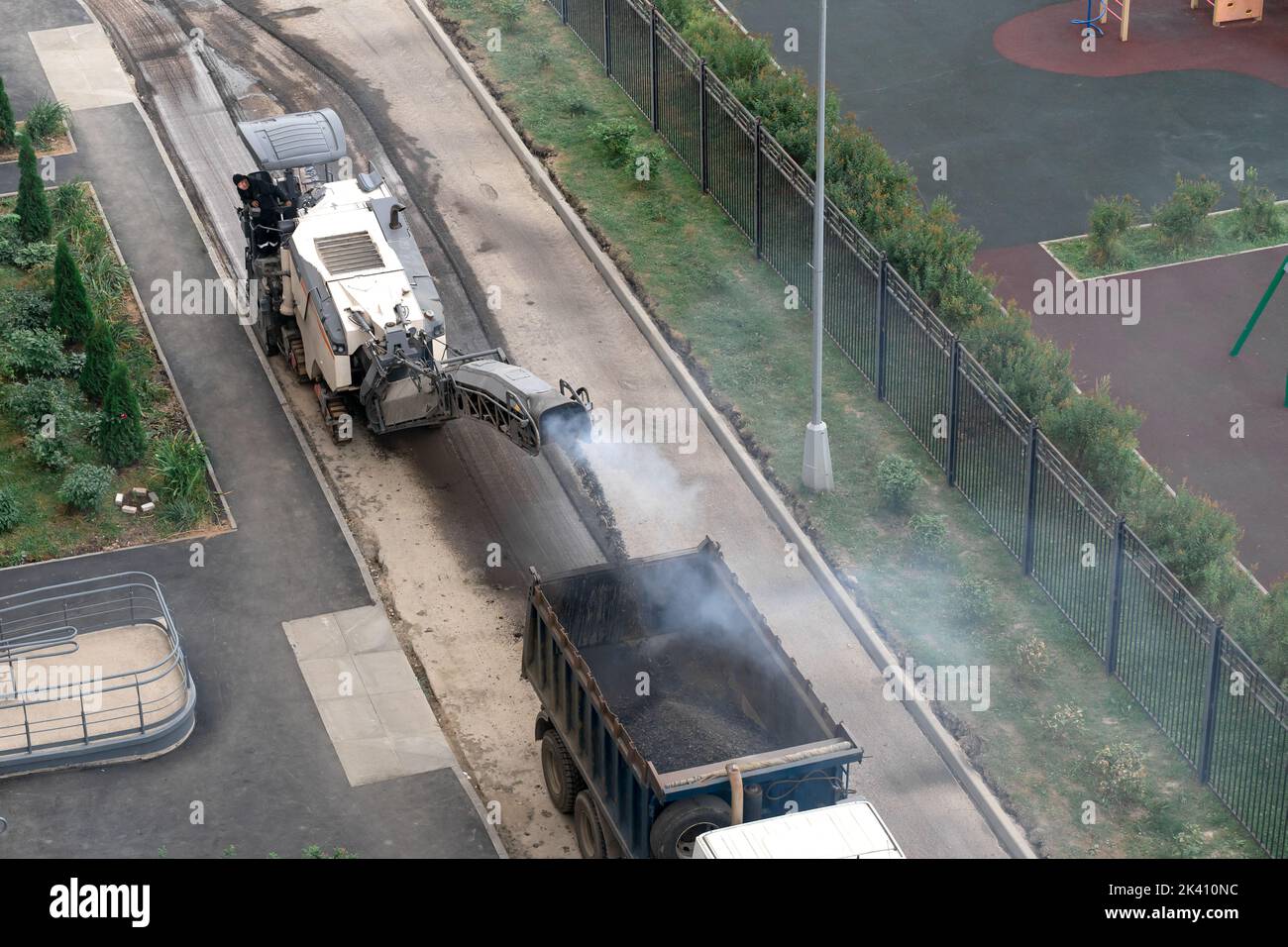 Asphalt milling machine working on the street. road surface milling in ...