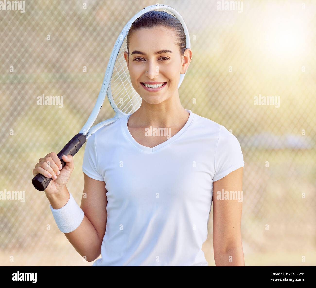 Portrait of tennis woman at the tennis court with a smile on her face ...