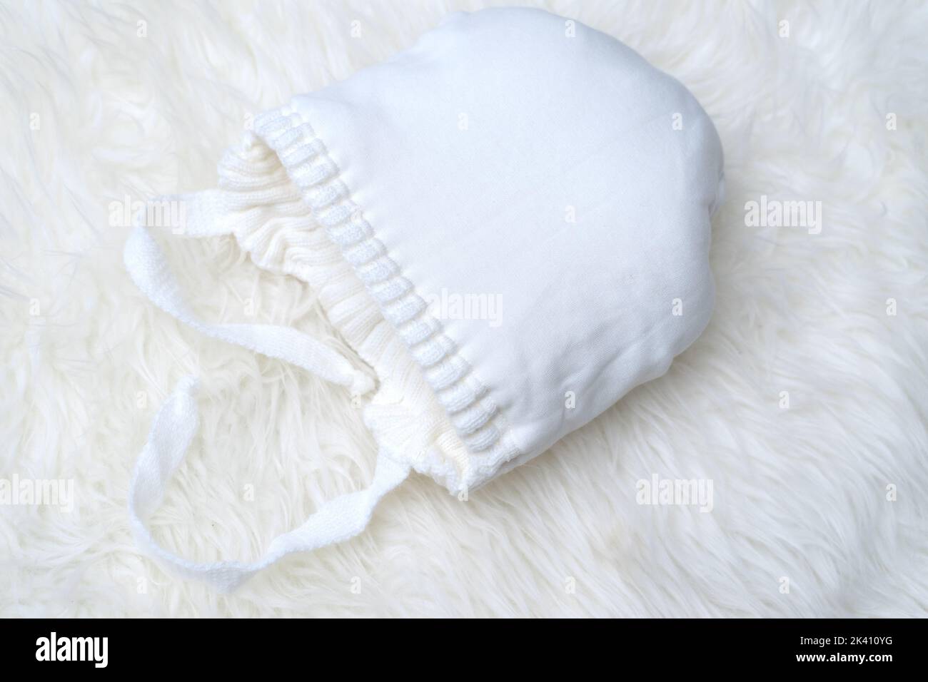 white baby woolen hat turned inside out. cotton lining Stock Photo - Alamy