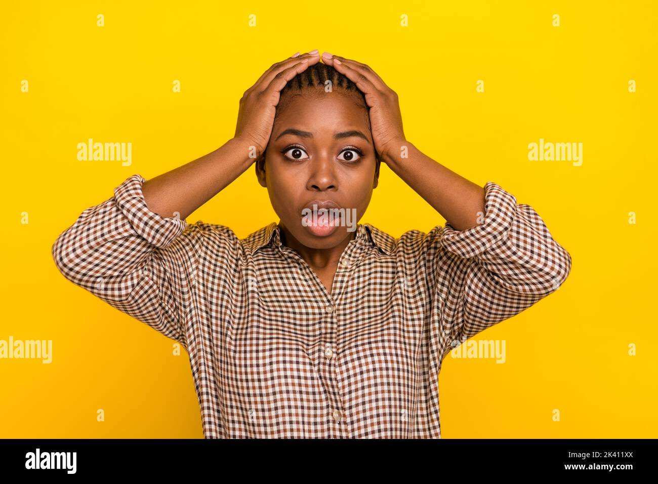Photo of shocked impressed woman wear plaid shirt arms head open mouth ...