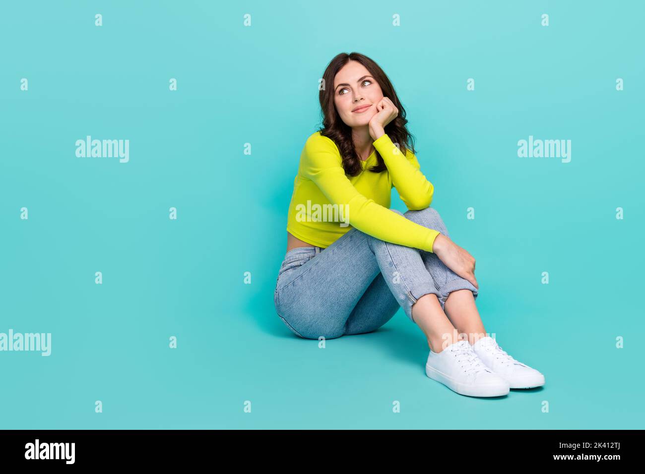 Full length portrait of minded lovely person sit floor hand touch cheek ...