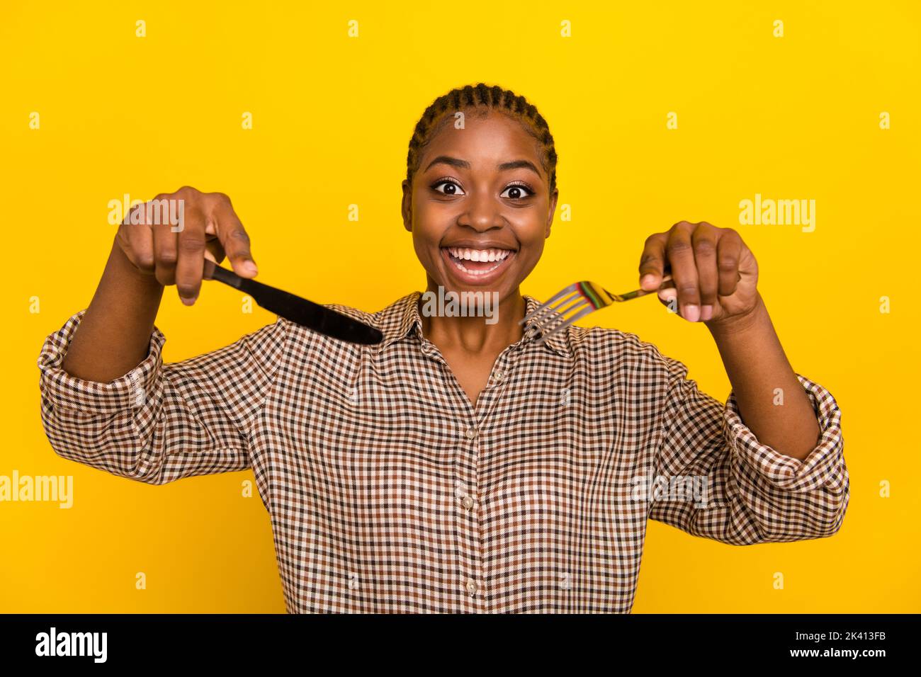 Photo of charming excited woman wear plaid shirt eating tasty dish ...