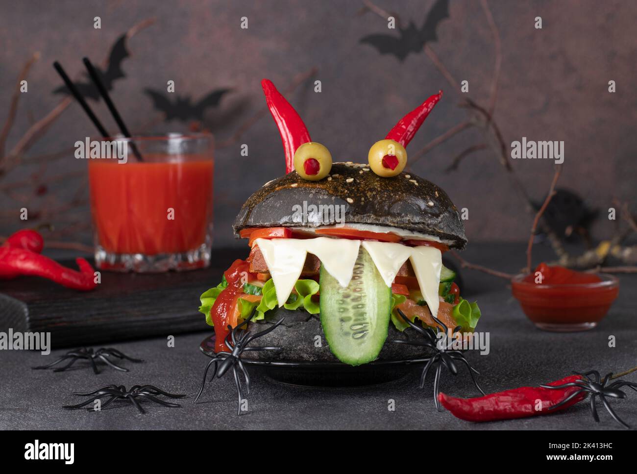 Funny monster black burger with fish, toast cheese, cucumber, tomato ...
