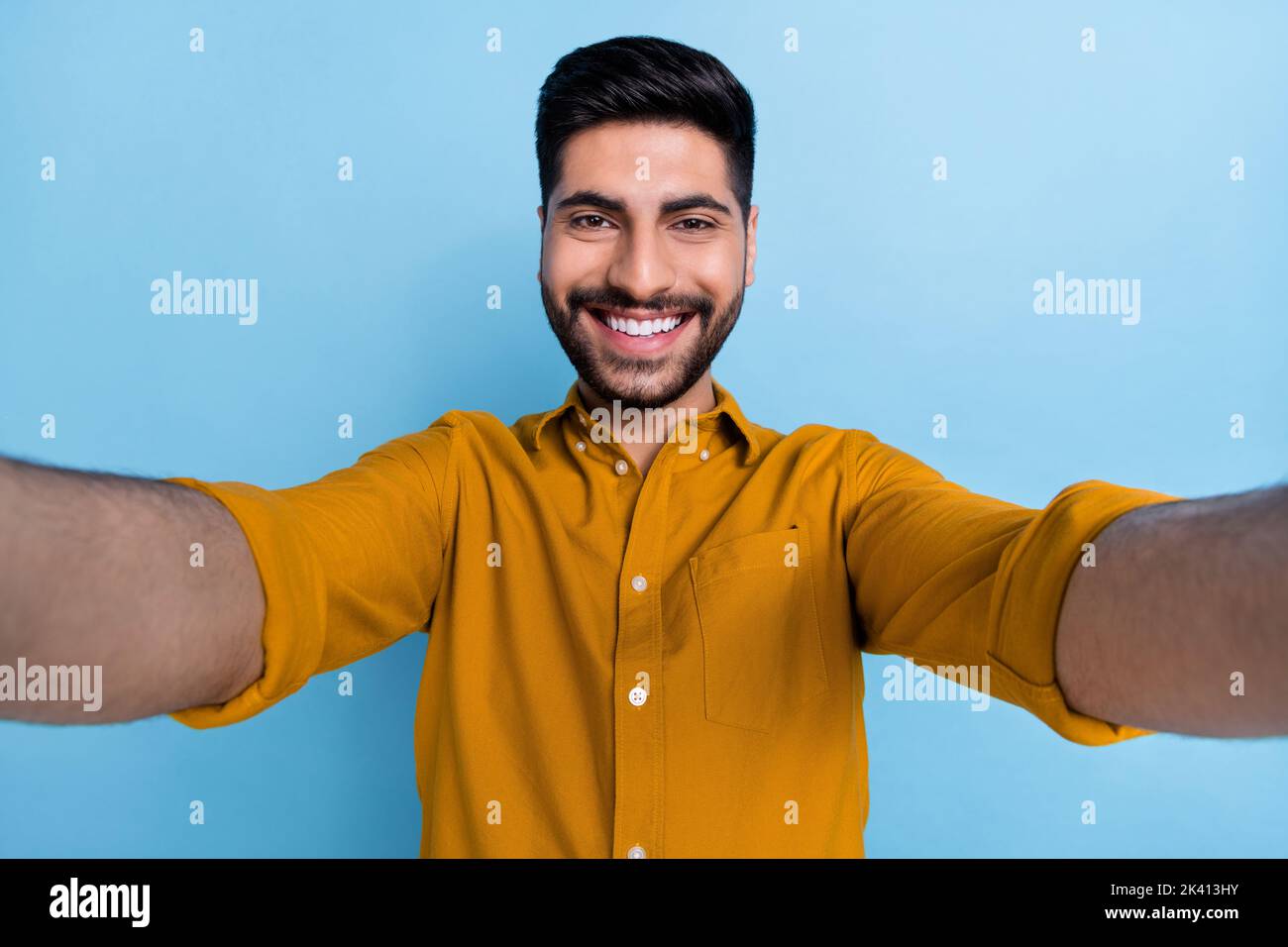 Photo of handsome smiling carefree young man dressed yellow shirt doing ...