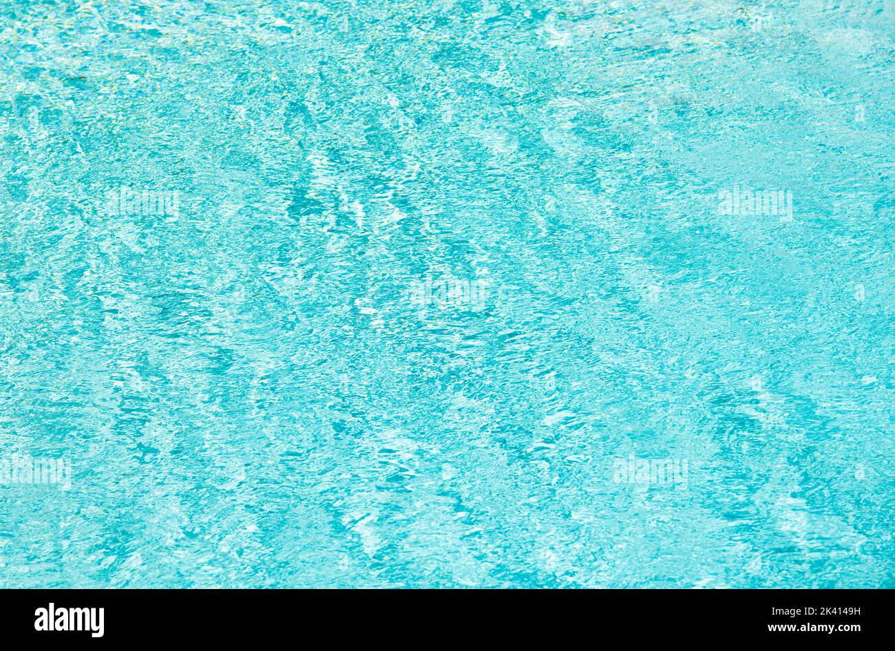 turquoise color background of swimming pool water with ripples in bali ...