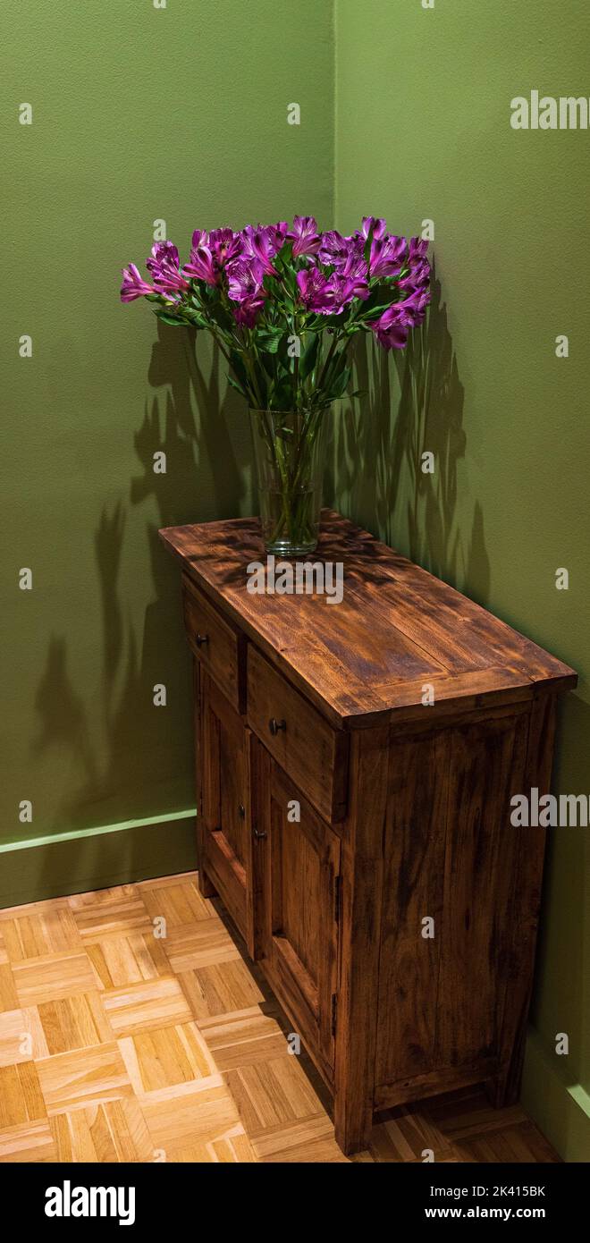 Lily flowers bouquet on vintage wooden chest of drawers in green ...