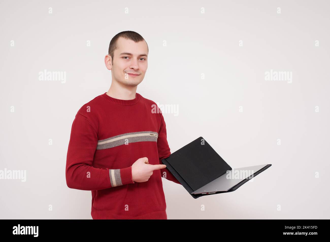 Happy smiling young man with black folder, isolated over white ...
