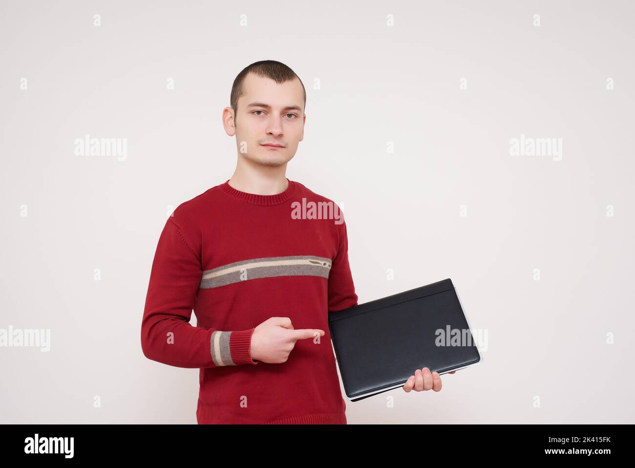 Happy smiling young man with black folder, isolated over white ...