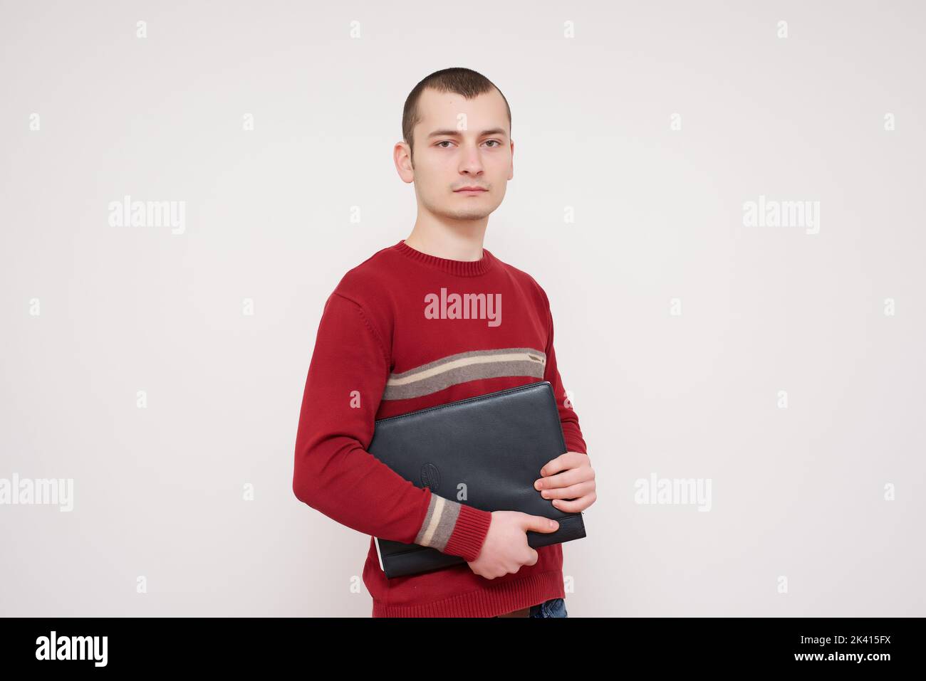 Happy smiling young man with black folder, isolated over white ...