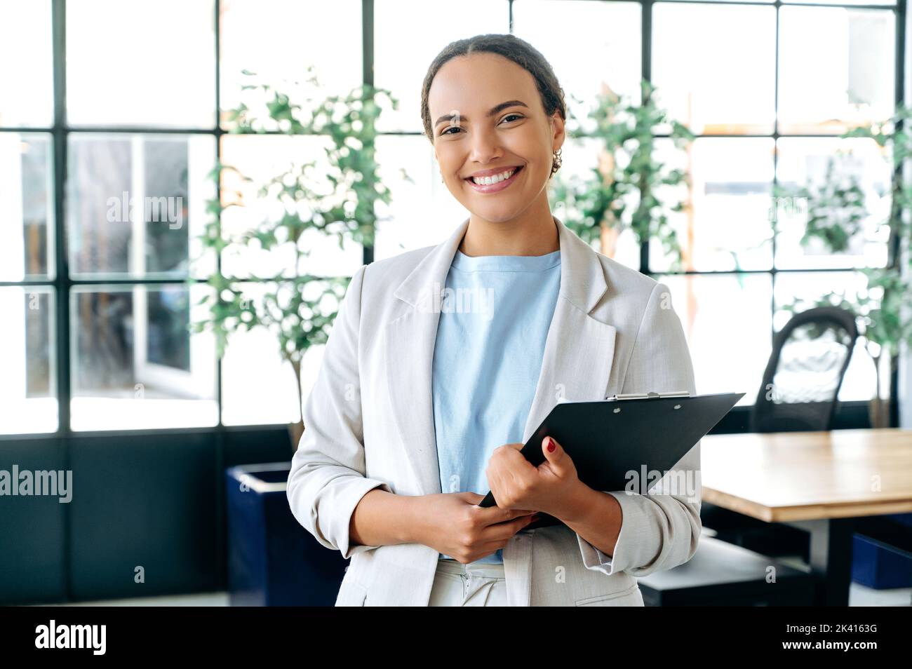 Portrait of a successful satisfied beautiful mixed race business ready ...