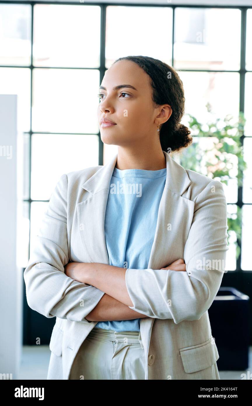 Pretty, pensive mixed race business lady, hiring manager, broker, in ...