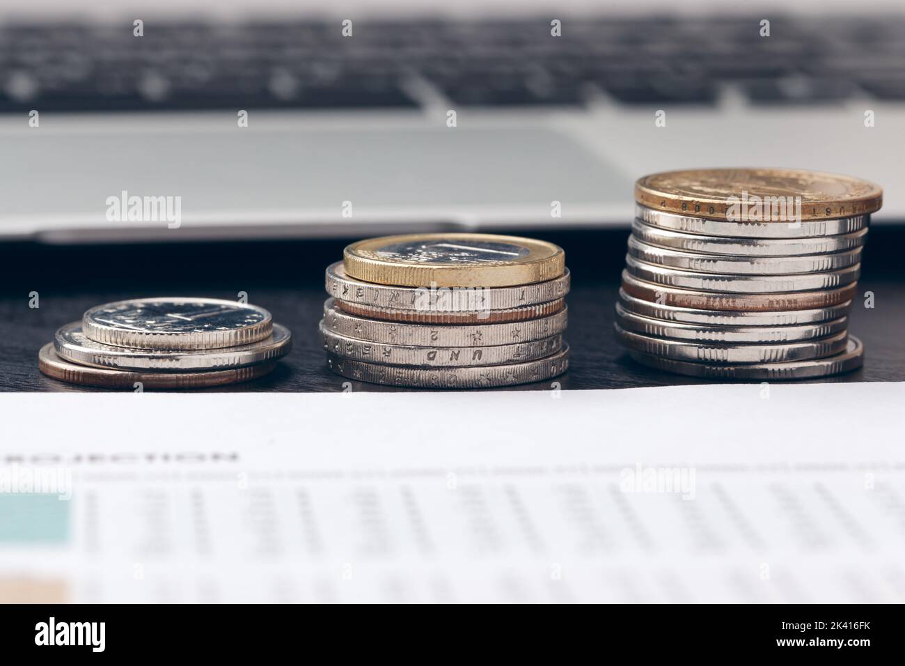 pile of money coins with graph paper on wood table, concept in account ...