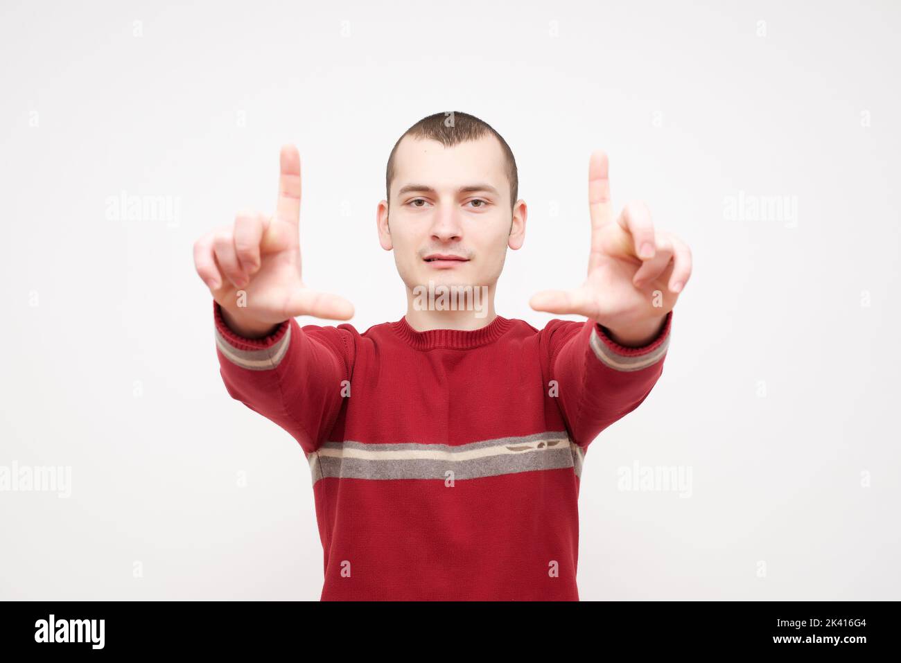 Male guy showing a loser sign stock photo Stock Photo - Alamy