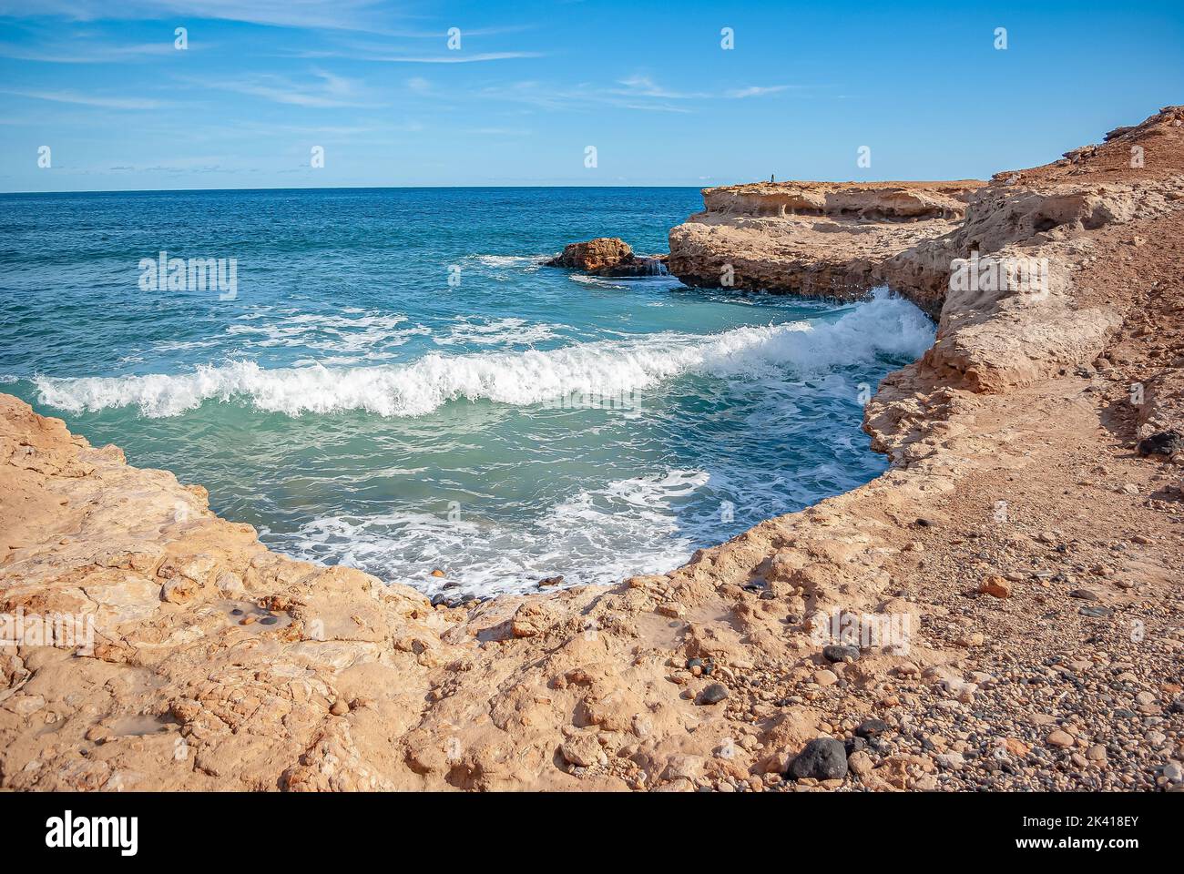 Sea waves with white foam run over pebbles. Stone shore. Background ...