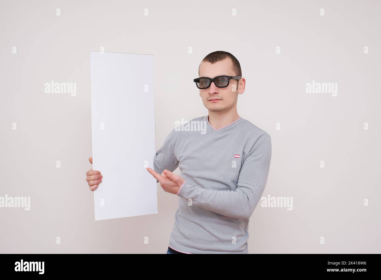 Happy smiling young business man showing blank signboard, isolated over ...