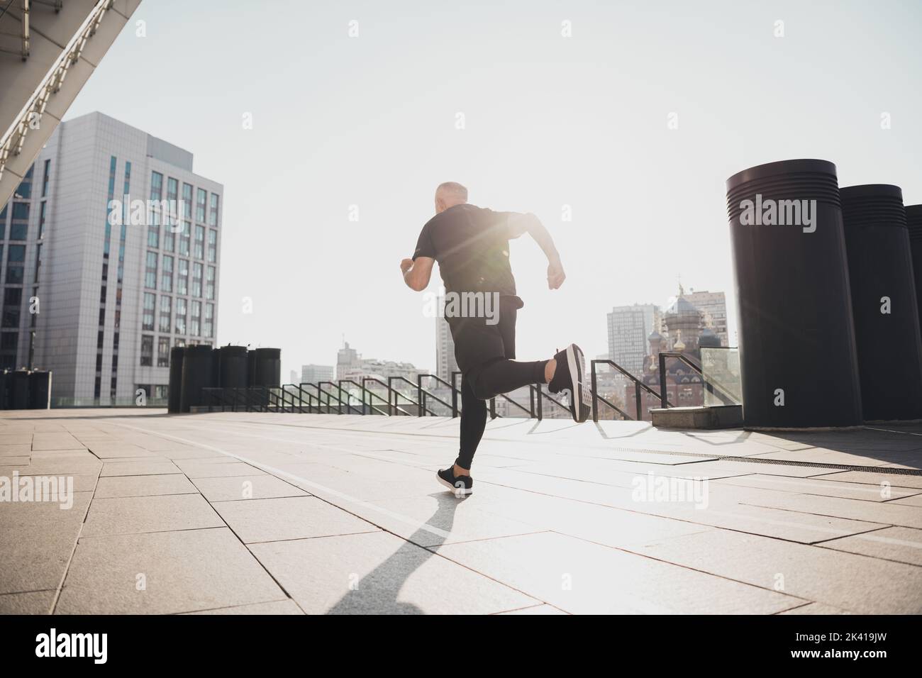 Rear back view photo of old confident man run sprint fast cardio ...