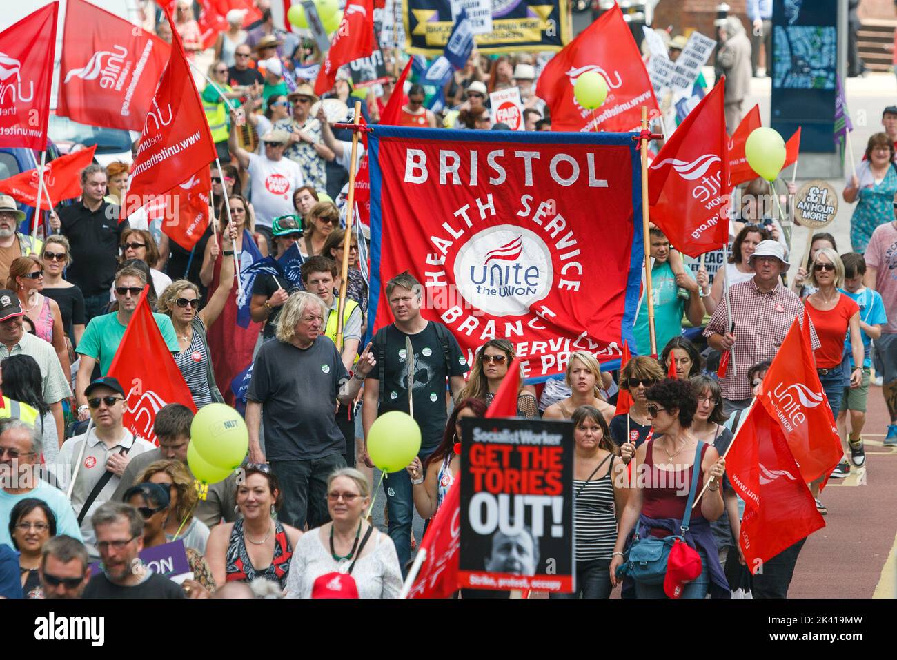 Protesters are pictured carrying trade union banners and placards ...