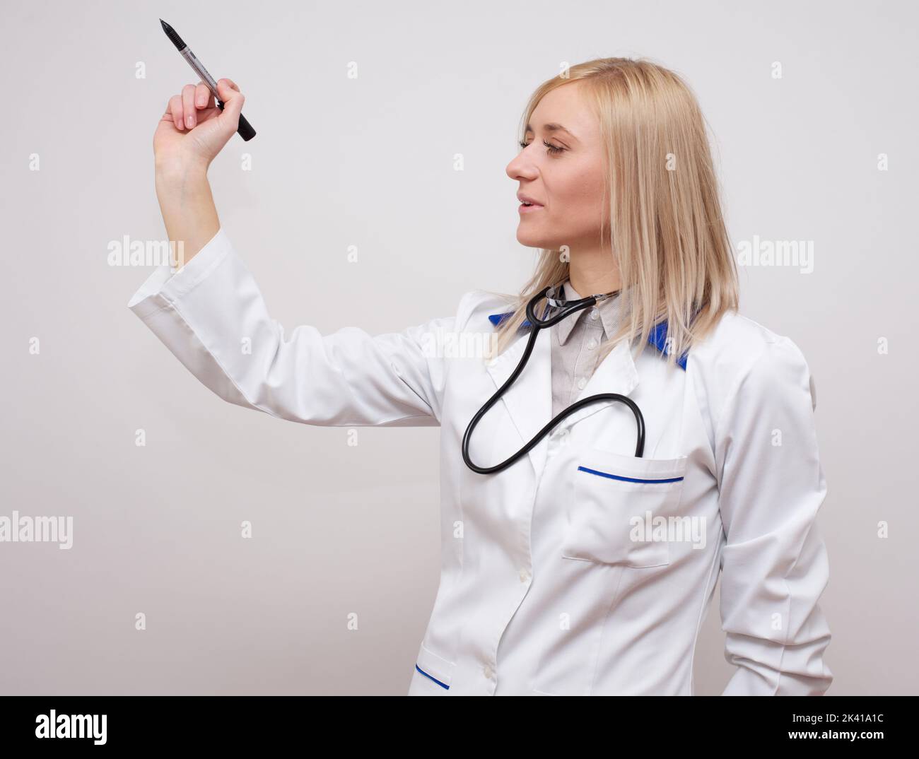 Woman doctor writing something on screen or transparent glass stock ...