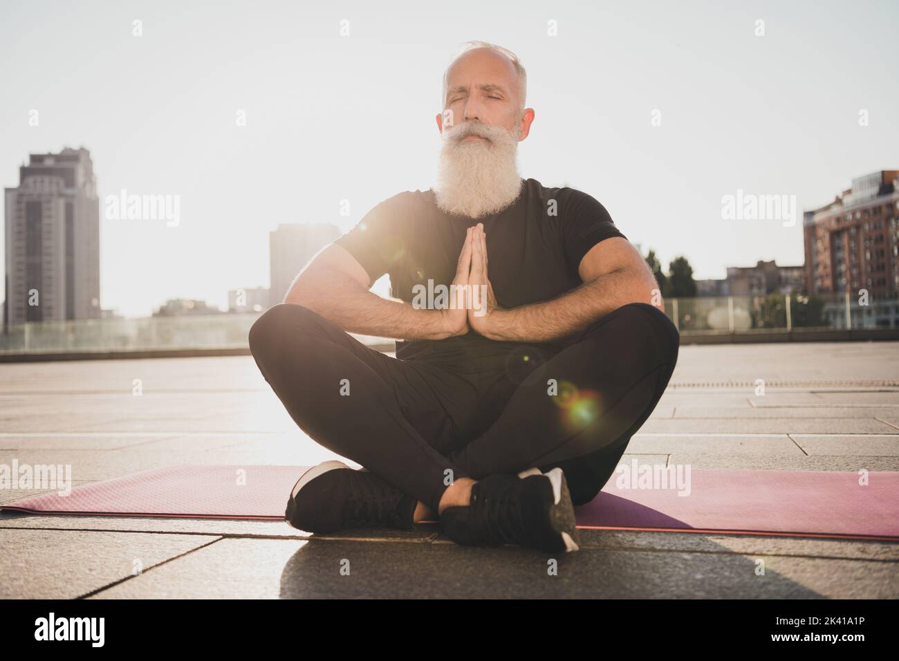 Photo Of Focused Mature Old Man Sit Fitness Mat Hold Hands Together