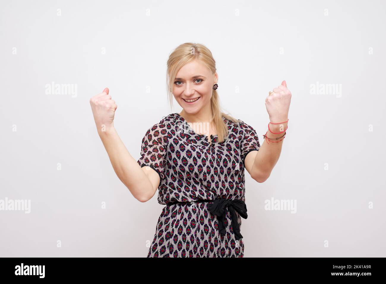 Closeup portrait of beautiful, pretty young model woman flexing muscles ...