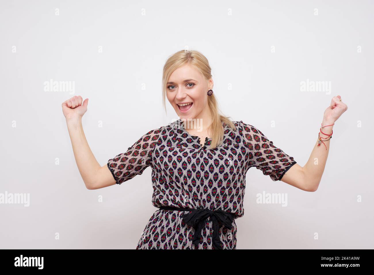 Closeup portrait of beautiful, pretty young model woman flexing muscles ...