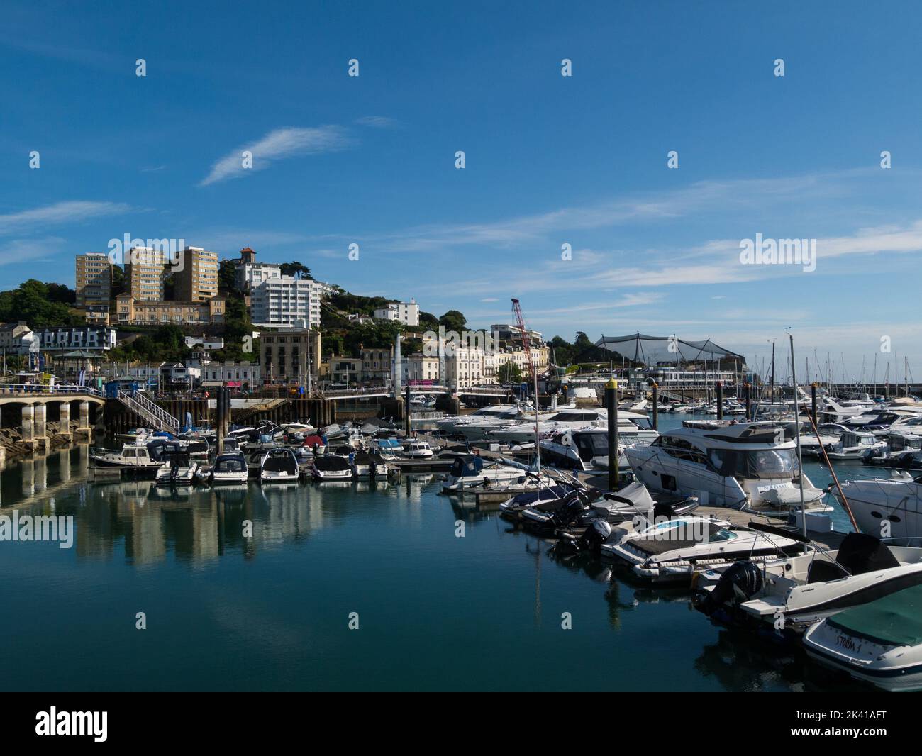 View along Torquay sea front with leisure craft moored at pontoons in ...