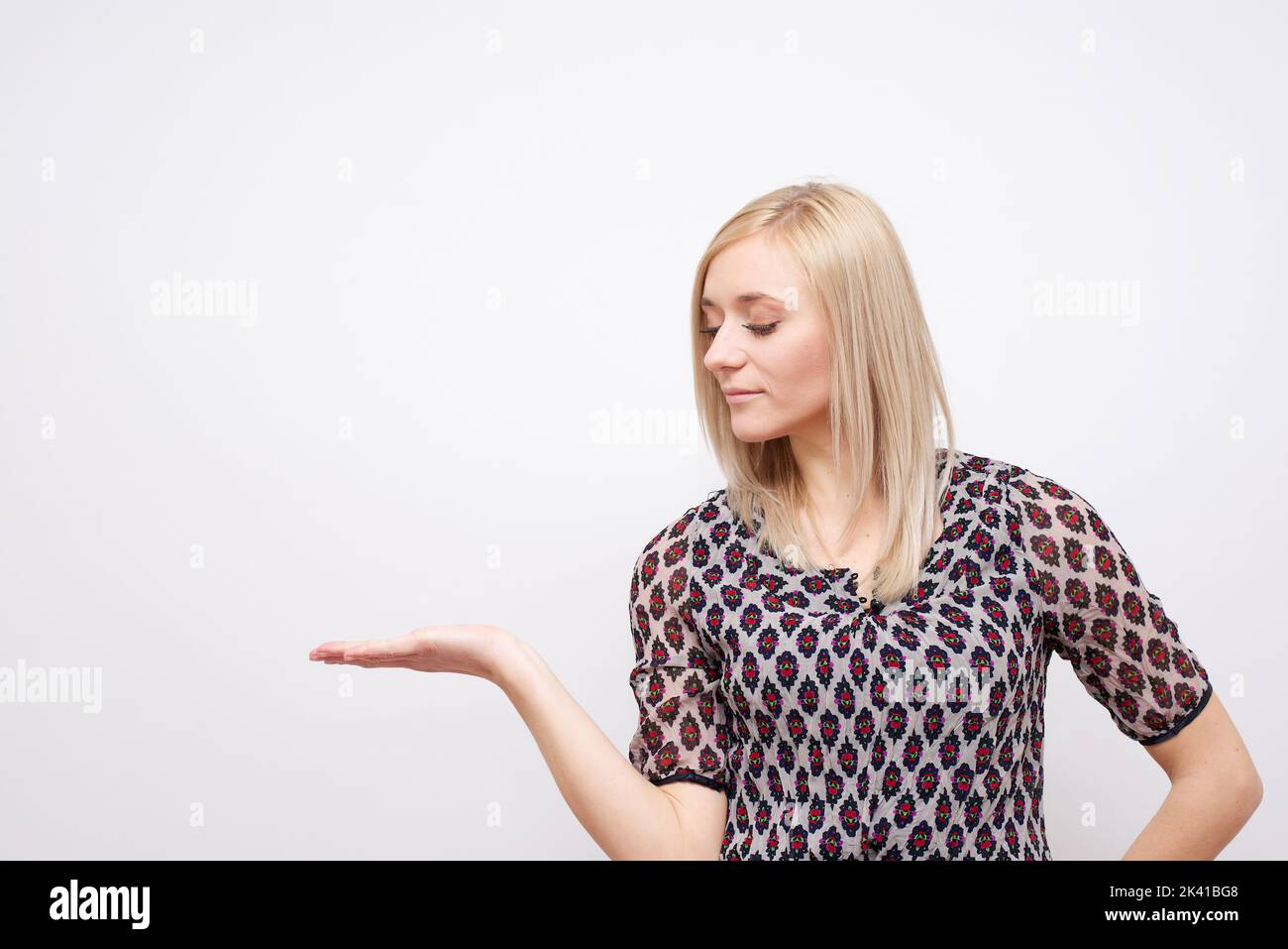 Young shows something isolated on white background stock photo Stock ...