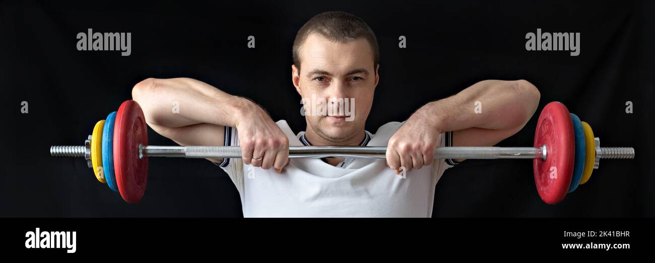 A strong, healthy man with muscles, training at home in the plank ...